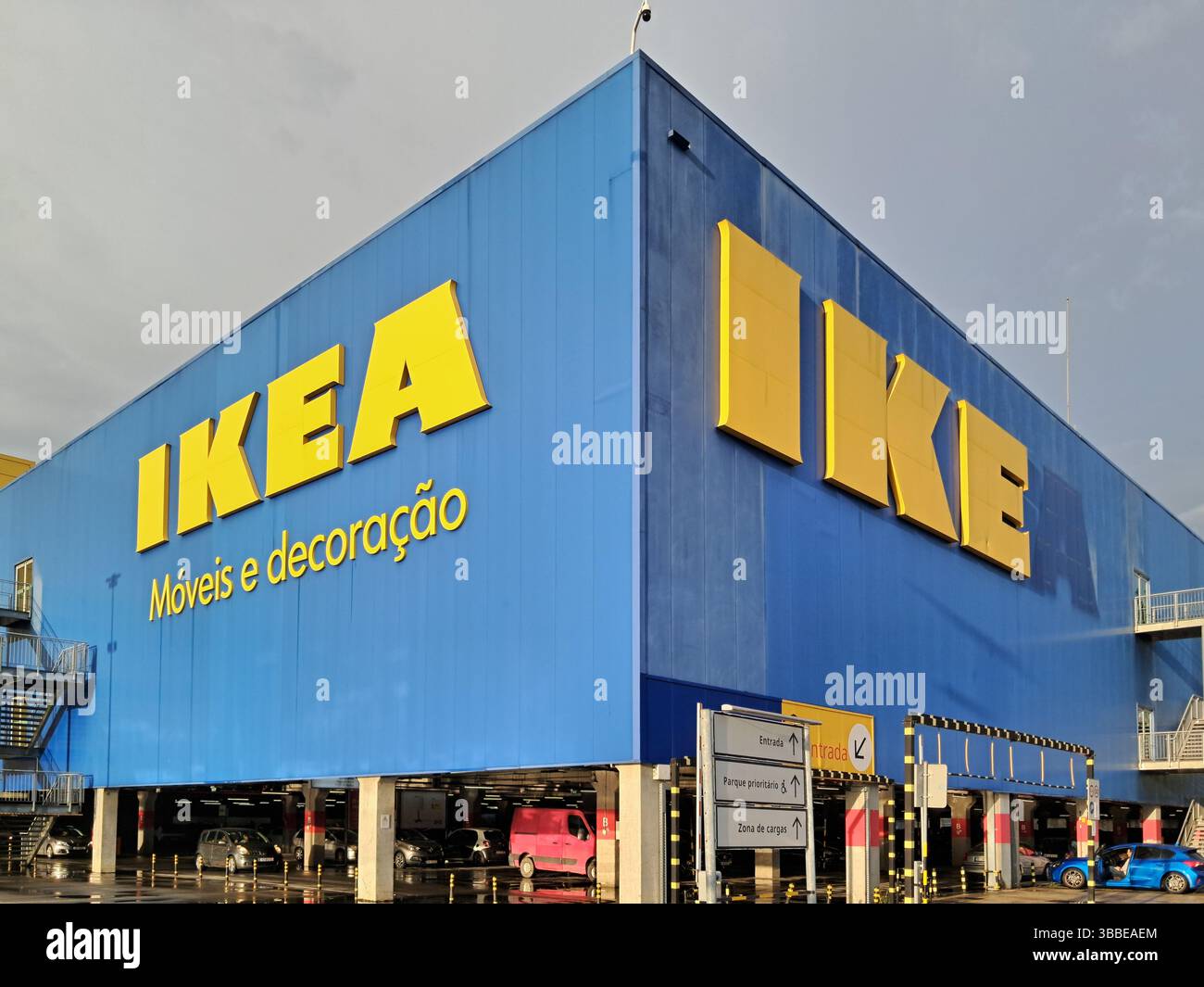 Big ikea store building with yellow logo and brand name, showing the main entrance and parking ...