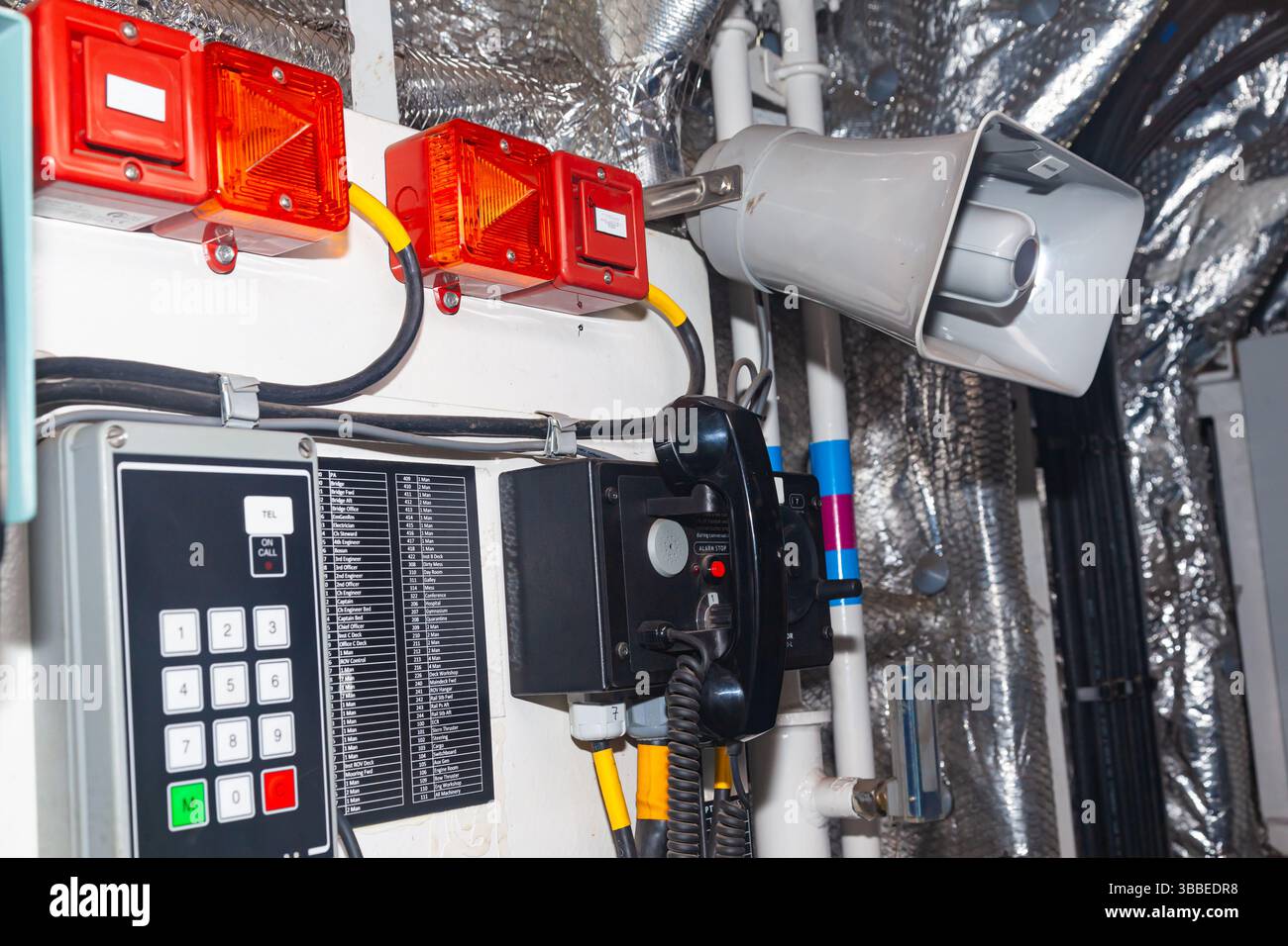 Part of the ship's engine room with a communications and alarm panel ...
