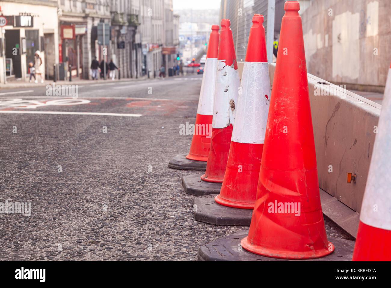 Traffic cones stand in a row on an asphalt road. Devices for temporary ...