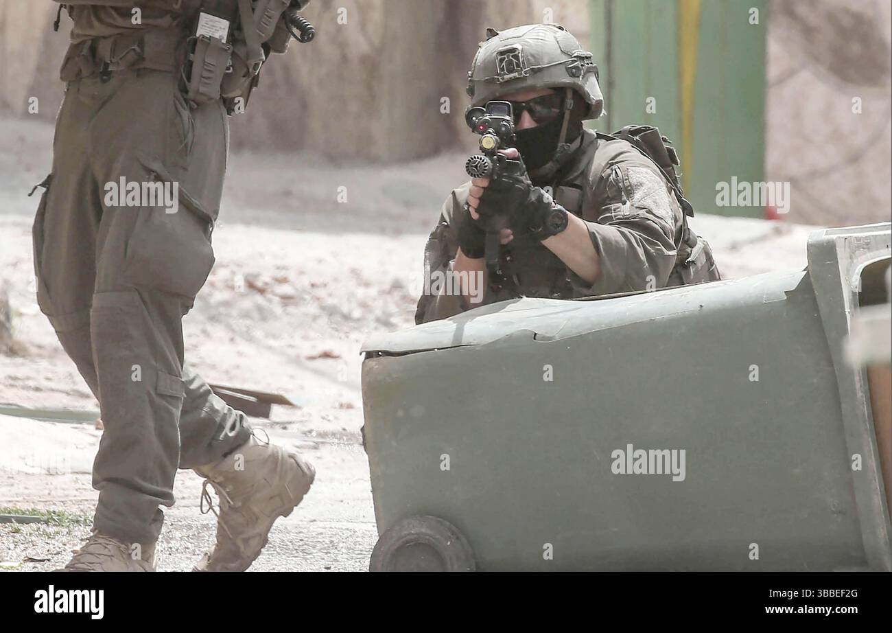 Nablus, Palestine. 15th May, 2025. An Israeli soldier takes position ...