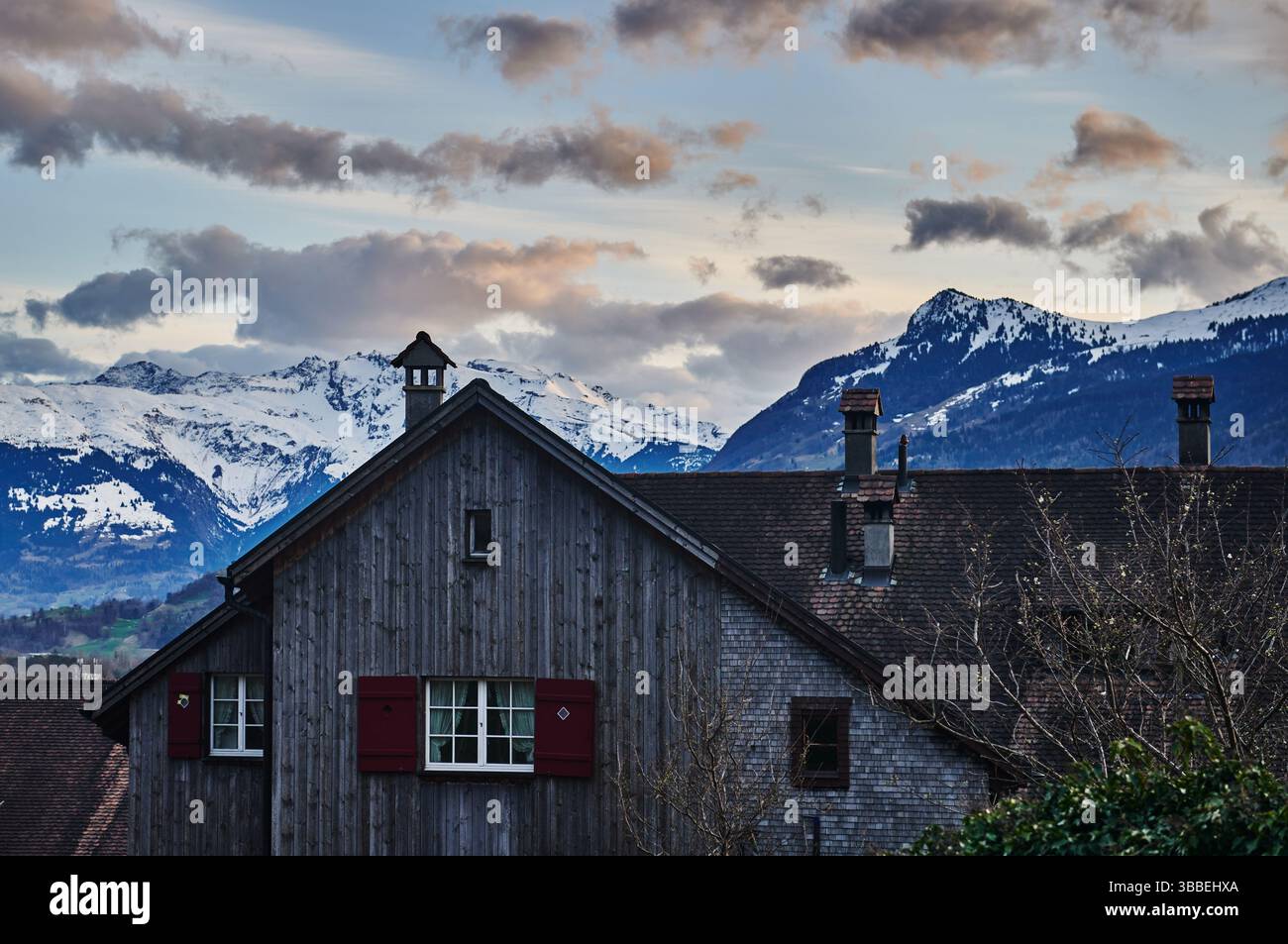 Swiss style homes with mountains in the background in Liechtenstein ...