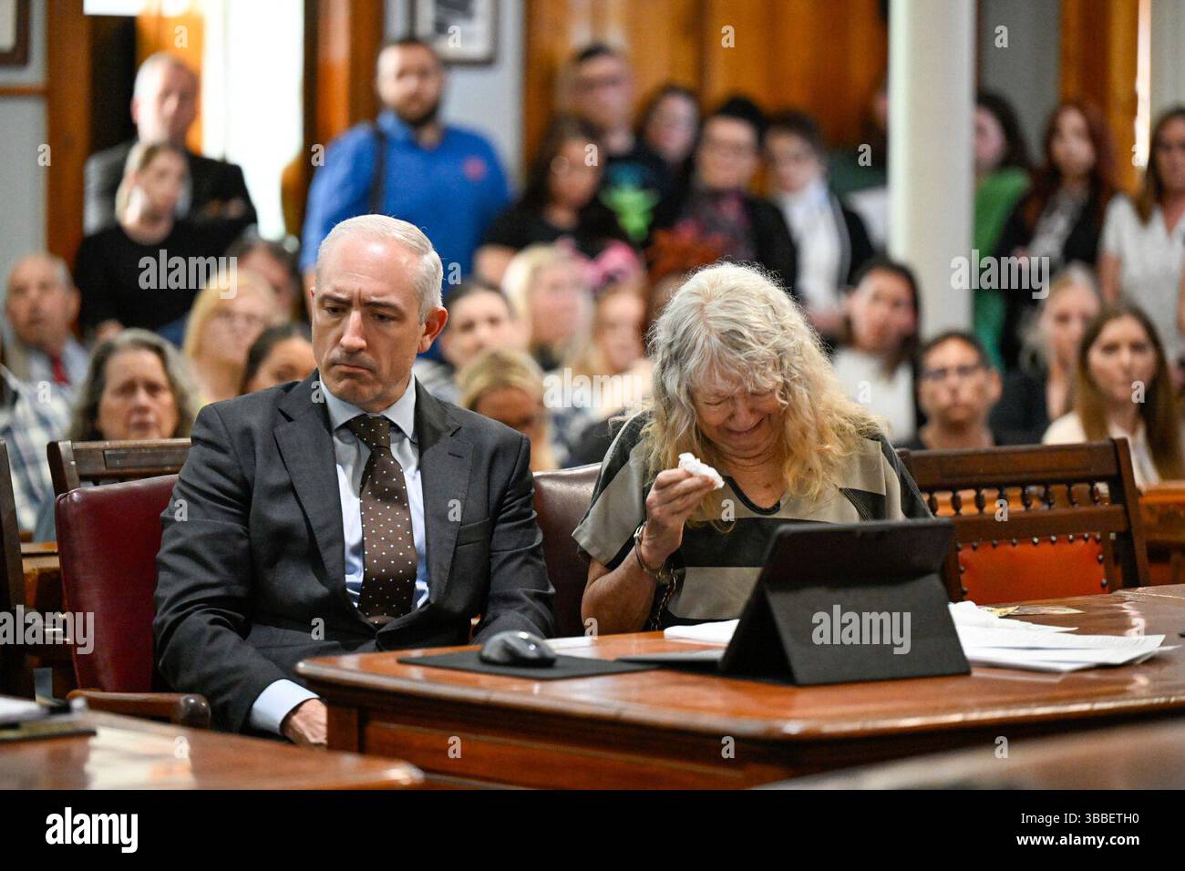 Marshella Chidester sits beside her attorney and cries while listening ...