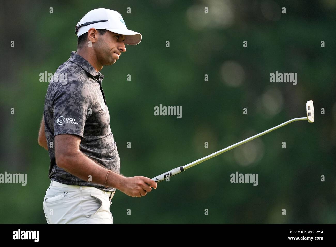 Aaron Rai, of England, reacts after missing a putt on the ninth hole ...