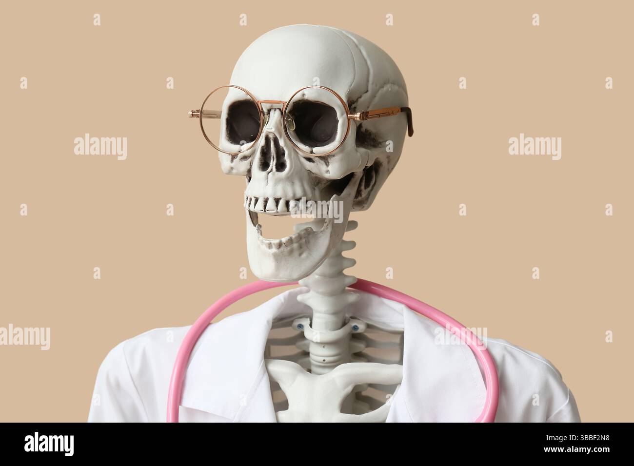 Human skeleton in doctor uniform on beige background Stock Photo - Alamy