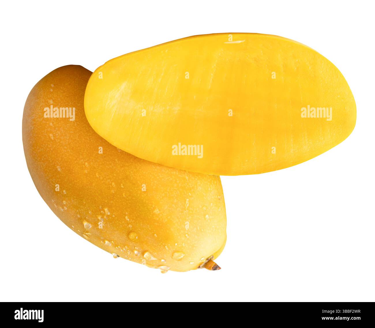Single ripe yellow mango fruit with half and water droplets in stack is ...