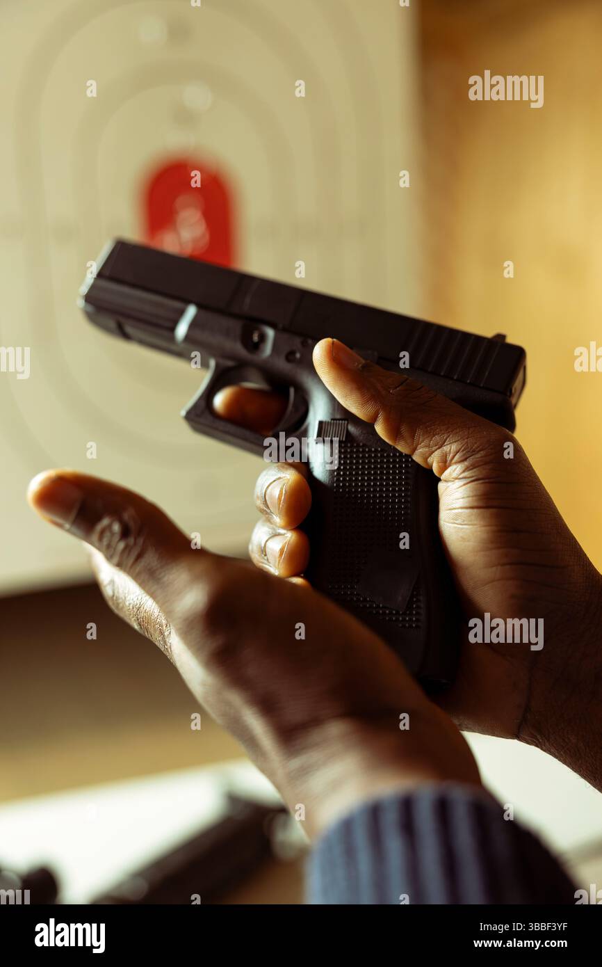 Firing range facility client reloading handgun following safety ...