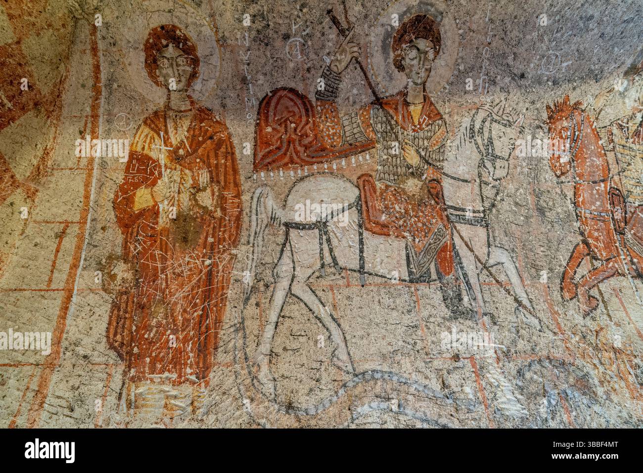 A fresco of Saint Onesimus and Saint George on horseback covers a wall ...