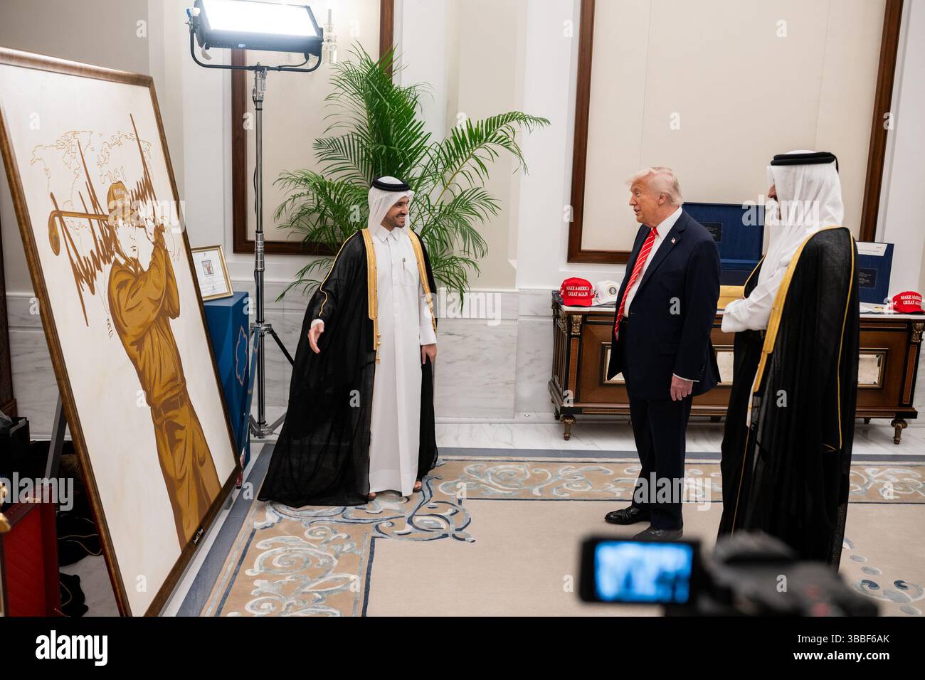 President Donald Trump walks with Amir of Qatar Sheikh Tamin bin Hamad ...