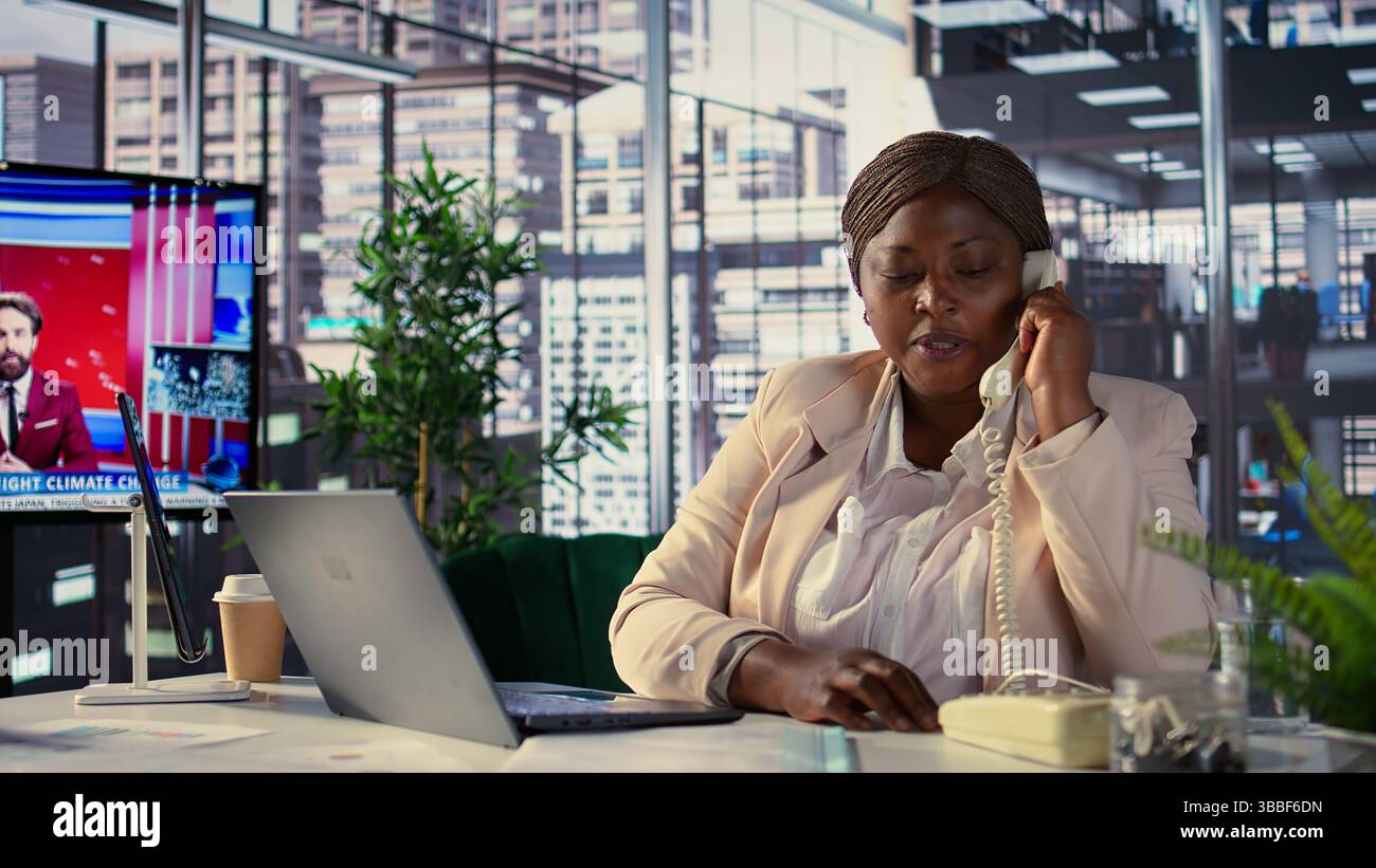 African american director uses landline phone call for financial review ...