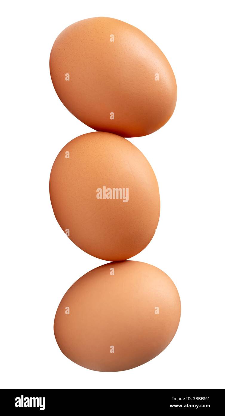 Three fresh brown chicken eggs in stack is isolated on white background ...