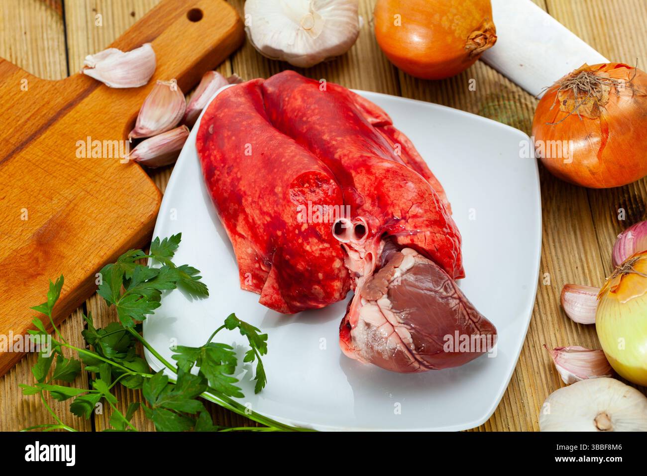 Raw lamb lungs and heart served with greens, nobody Stock Photo - Alamy