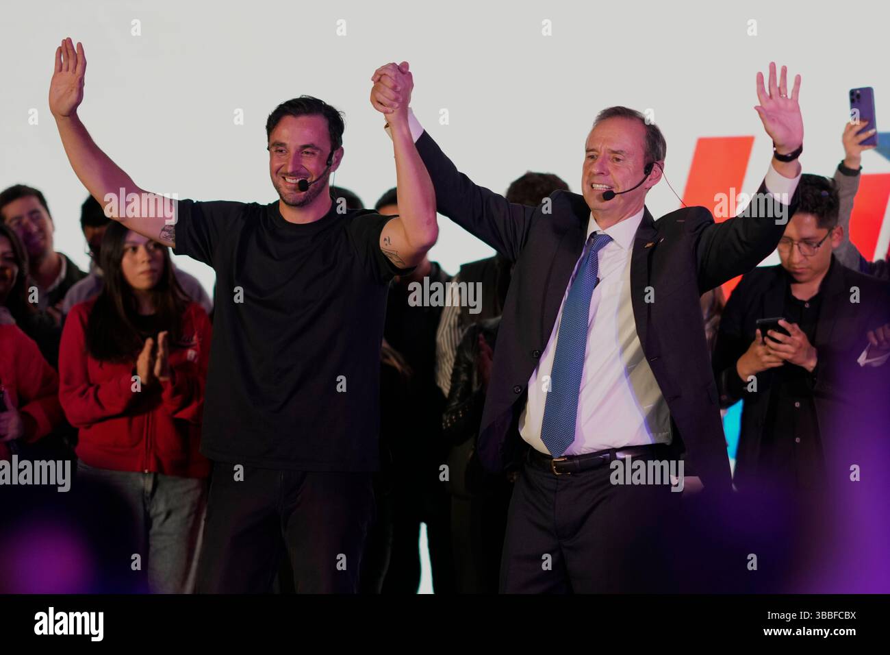 Presidential candidate Jorge "Tuto" Quiroga, right, and running mate Juan Pablo Velasco raise ...