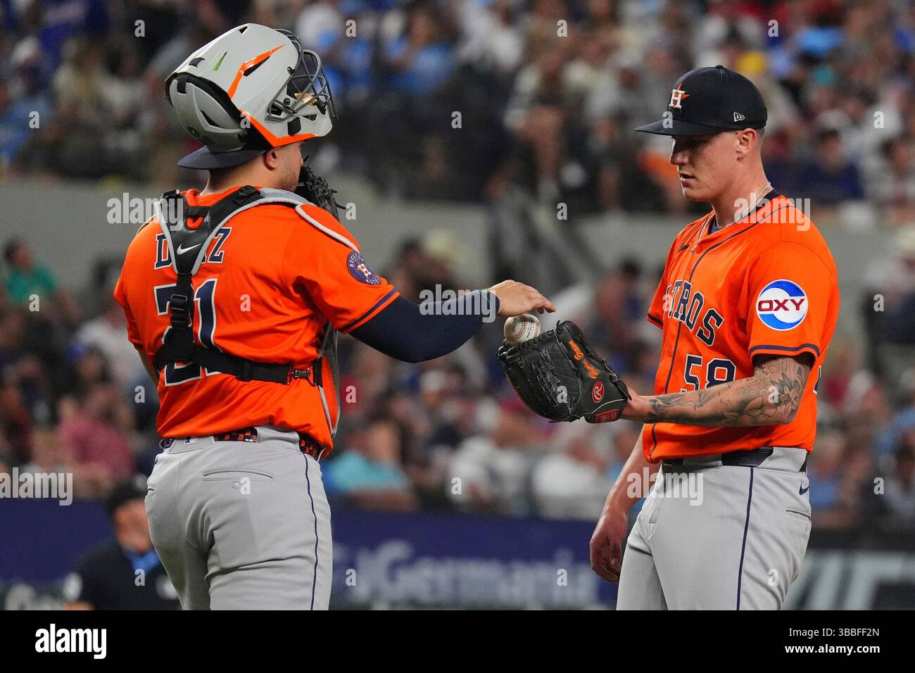 Houston Astros catcher Yainer Diaz (21) hands the game ball to starting ...