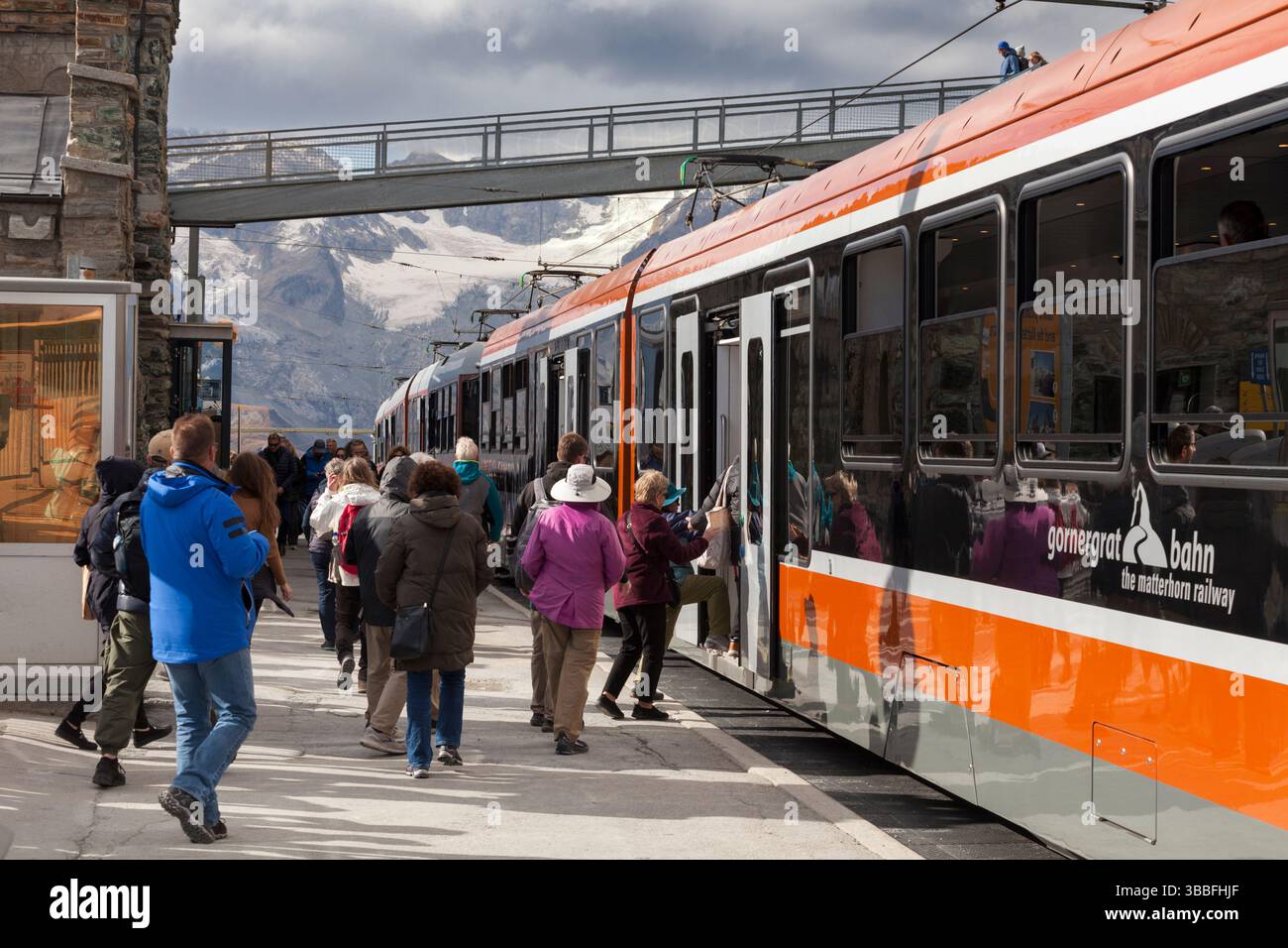 Passengers boarding Gornergrat Gotthard Bahn / Gornergrat Railway train ...