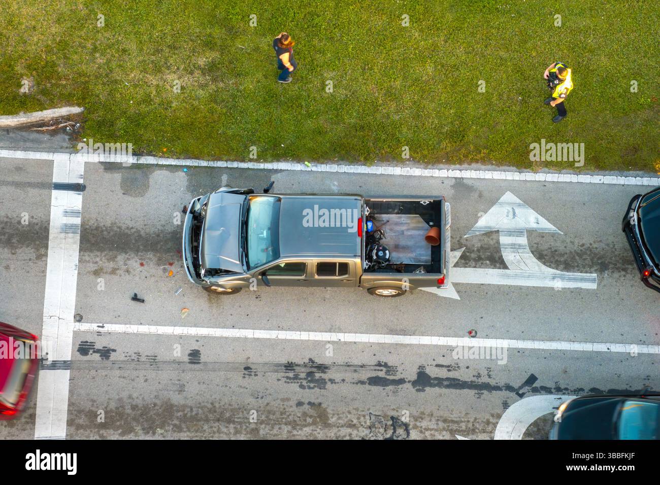 Car crash site with emergency services personnel and vehicles ...