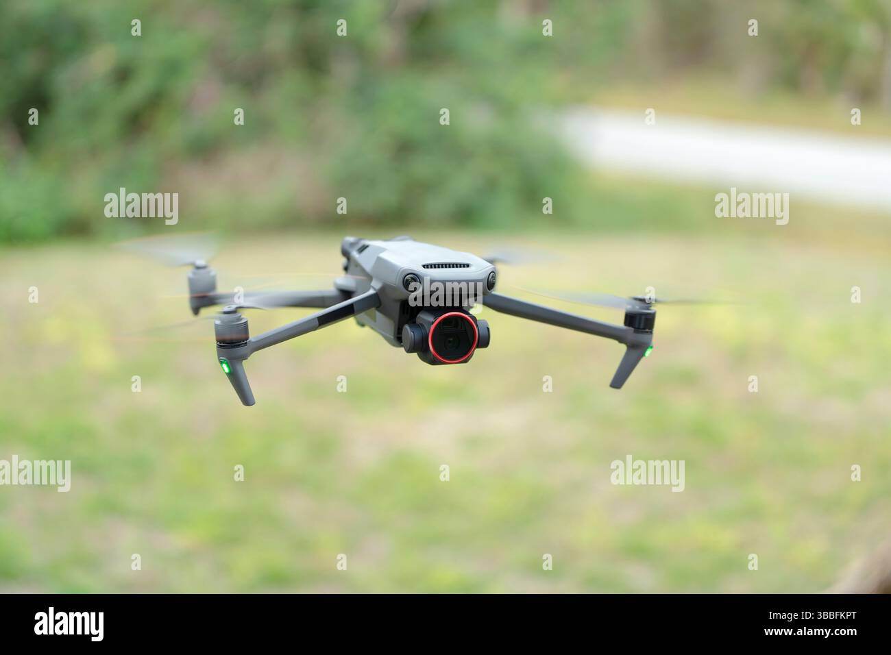 Drone aircraft with blurred fast rotating propellers and video camera ...