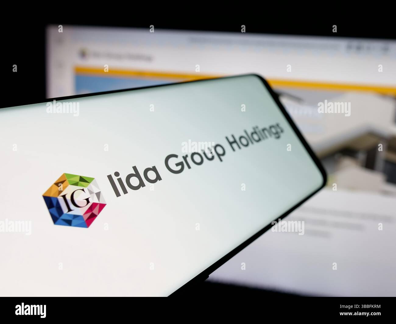 In this photo illustration, a smartphone with the logo of Japanese company Iida Group Holdings ...