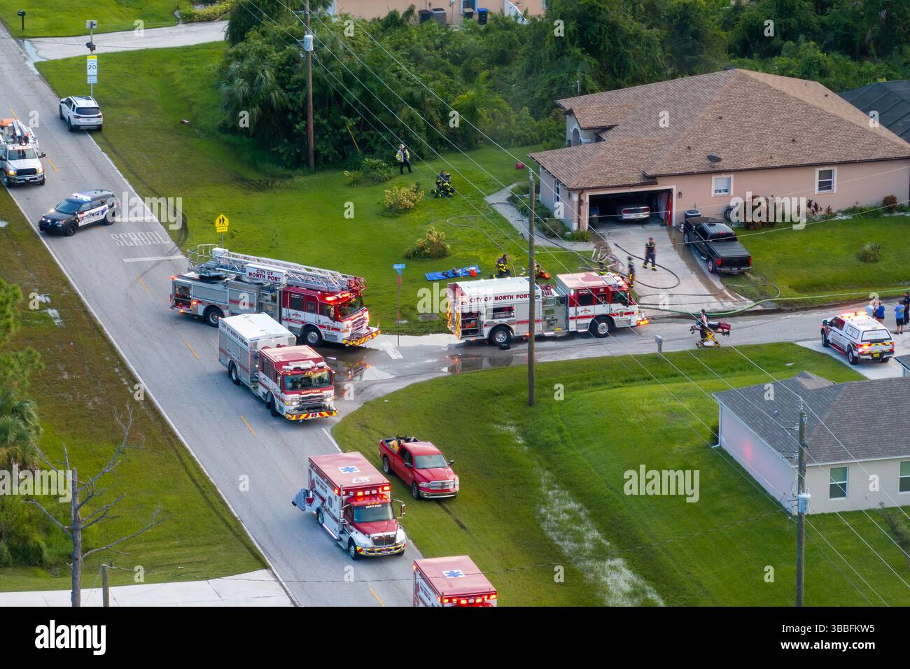 Firefighter trucks at fire alarm scene of suburban house. First ...