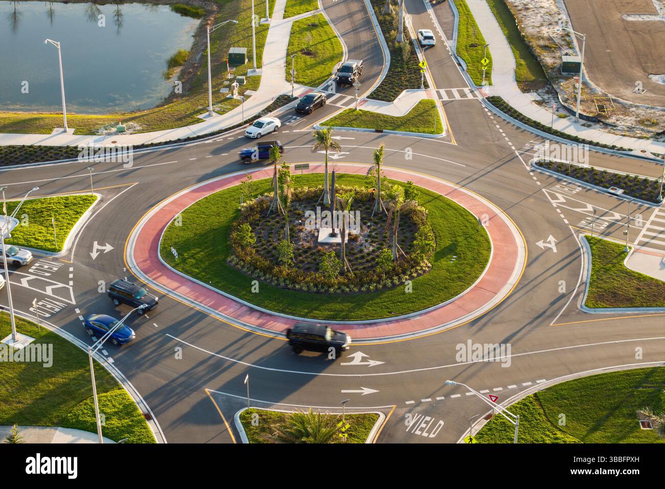 Traffic infrastructure in USA. Road roundabout intersection with ...