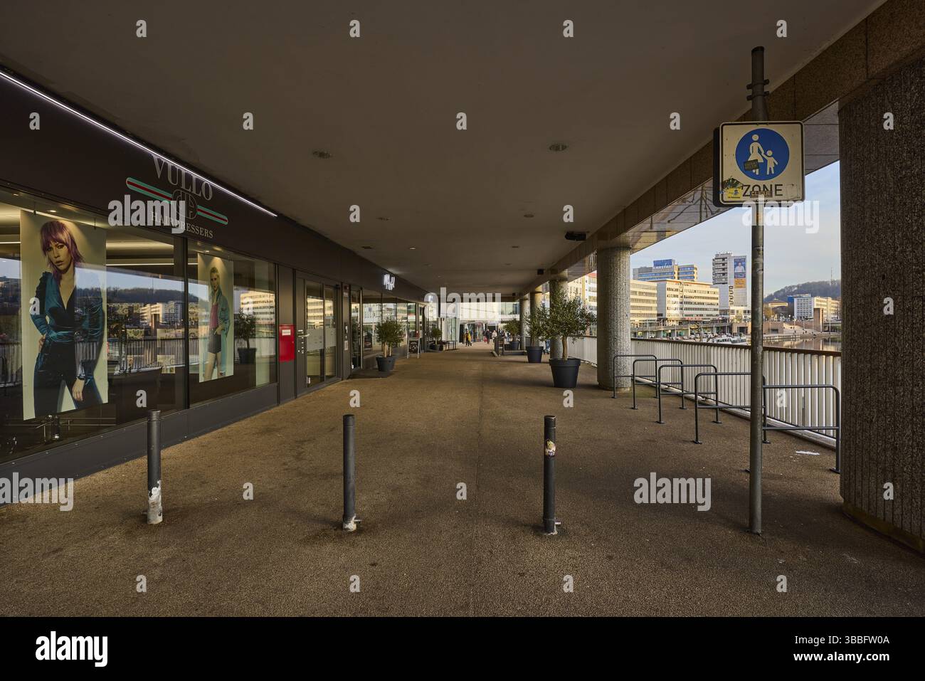 Pedestrian zone, barrier bollards, hairdresser, roofing, modern architecture, metal railings ...