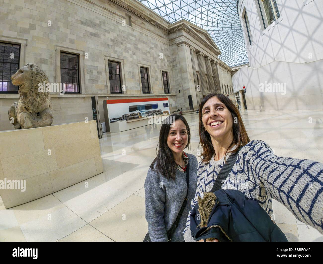 Two happy female tourists are taking a selfie with a fisheye lens at ...