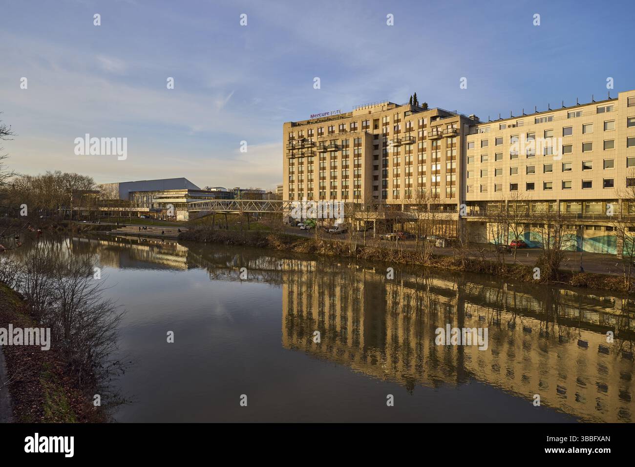 River Saar, modern architecture, trees, reflections on the water ...
