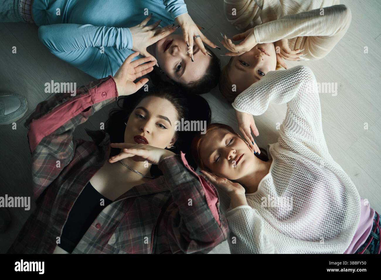 Group of Friends Lying and Making Peace Signs On Floor Stock Photo - Alamy