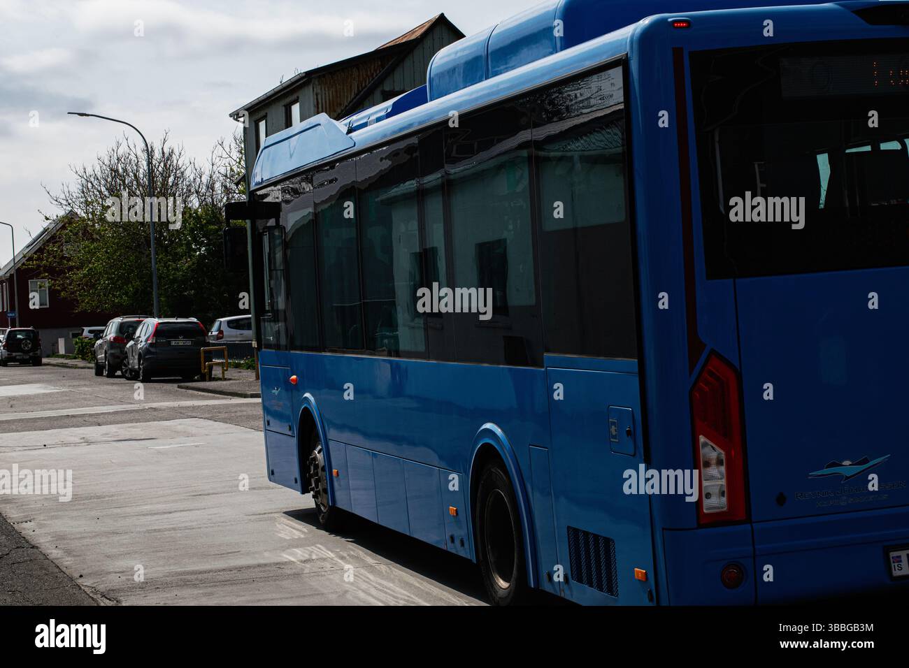 Akranes, Iceland - May 15, 2025: A vibrant blue city bus parks on a ...