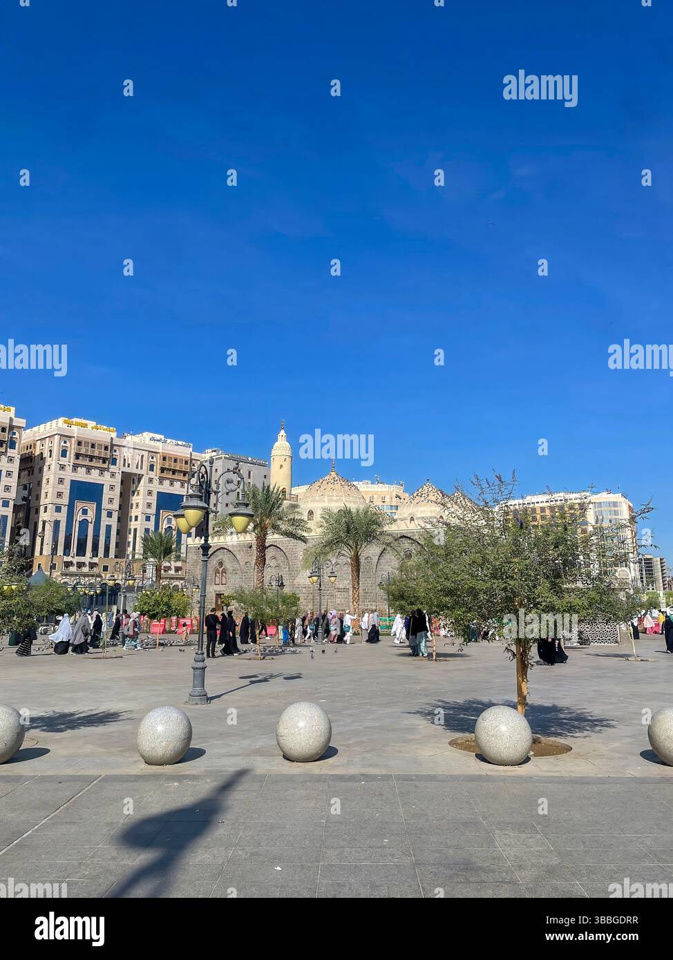 Peaceful public square in Madina with people, lights, and architecture ...
