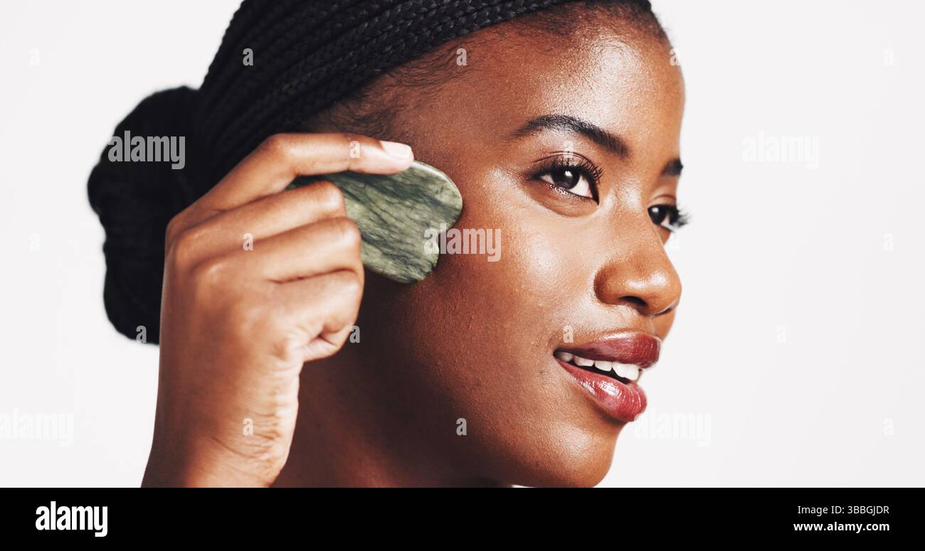 Beauty, skincare and black woman with gua sha in studio for lymphatic ...