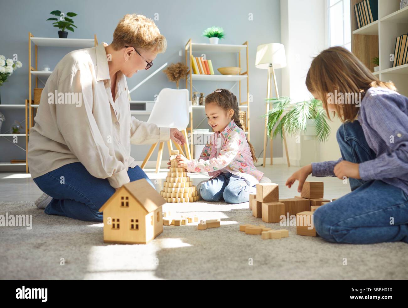 Happy family together, grandchildren and grandmother friendly playing ...