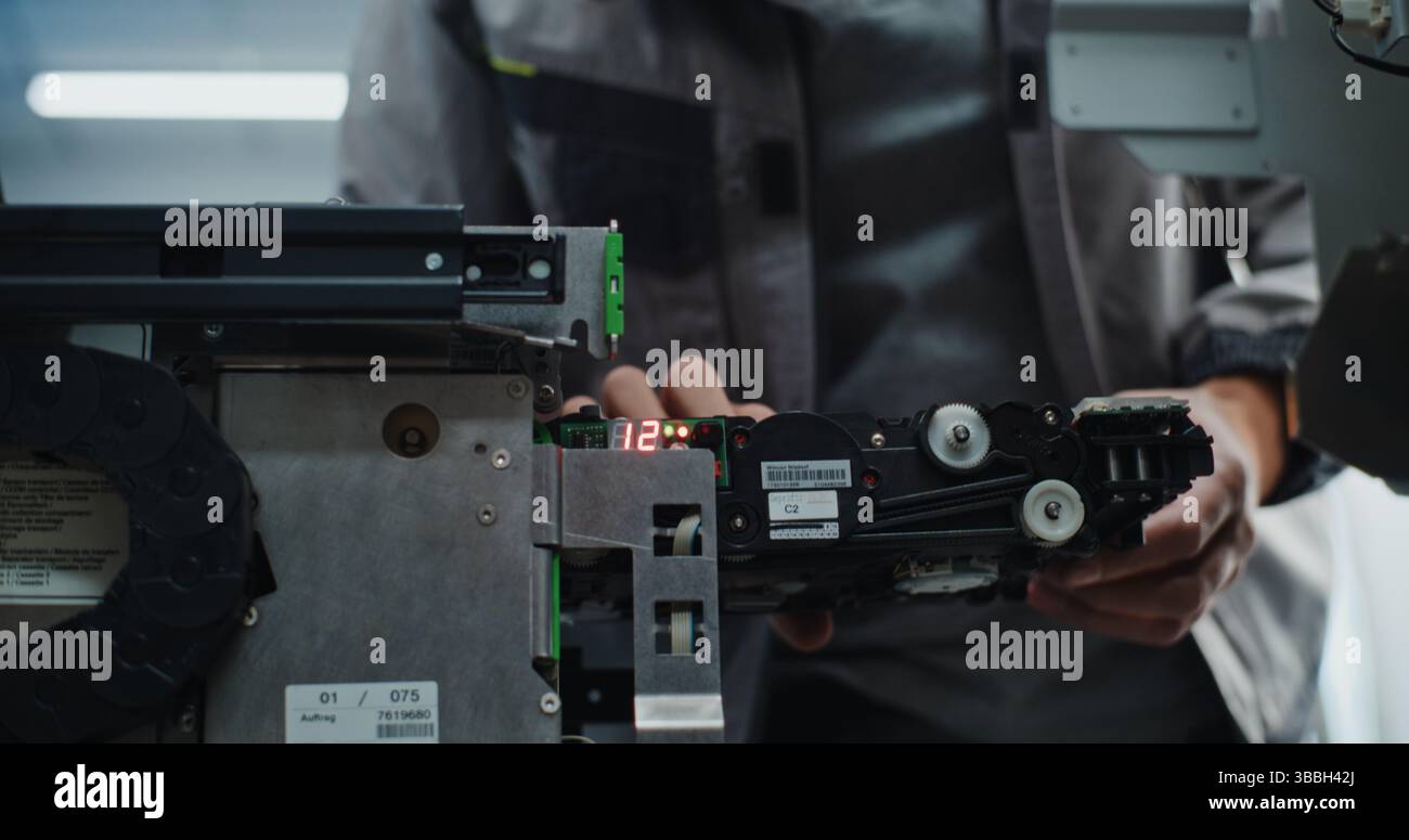 Atm technician in uniform performing hi-res stock photography and ...