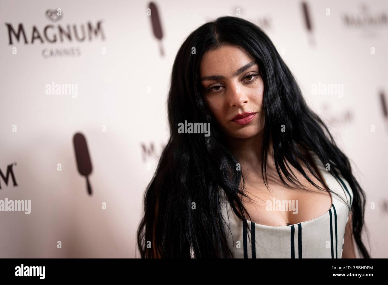 Charli xcx poses for photographers upon arrival at the Magnum Cannes ...