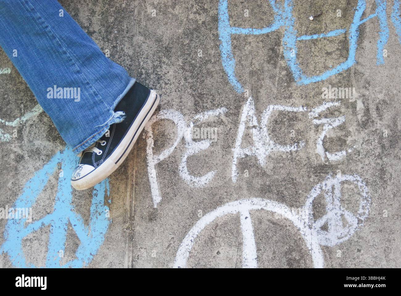 Black Lace up Sneaker In Front of Graffiti Covered Wall Stock Photo - Alamy