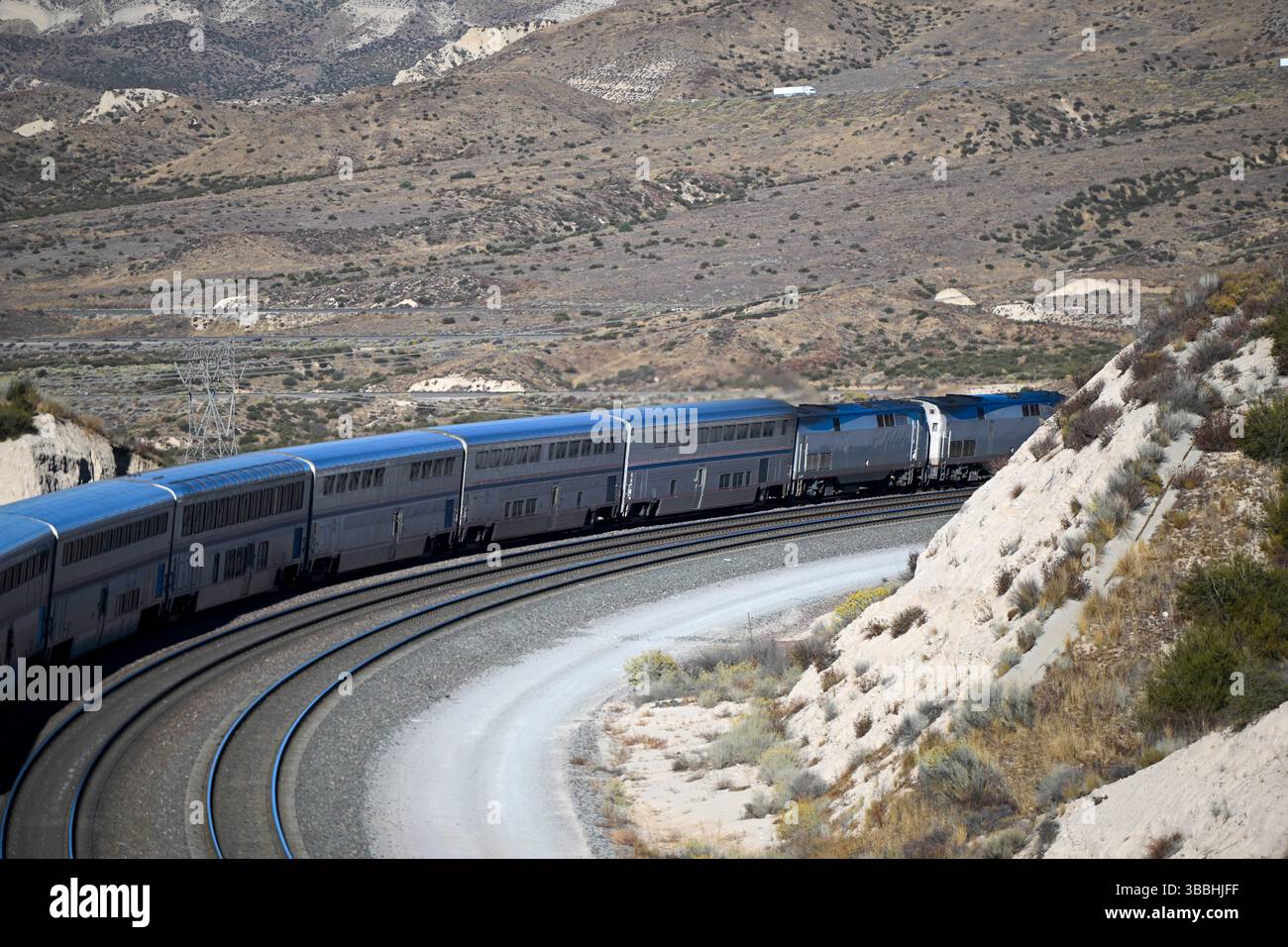 Passenger train rail cars descending tracks Cajon Pass California Stock ...