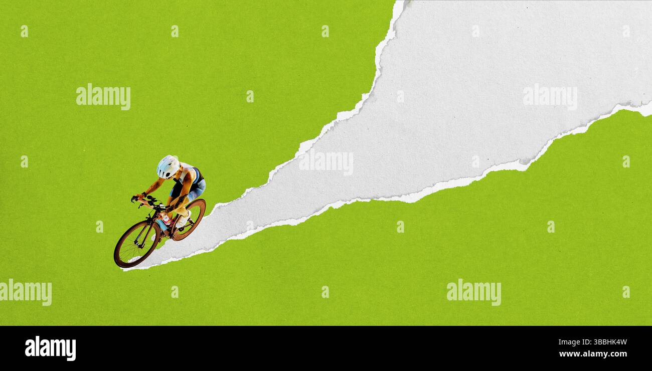 Female triathlete on road bike races over ripped white trail on green ...