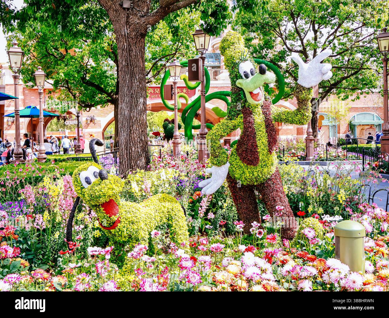 Colorful garden in theme park, whimsical Disney character topiaries in ...
