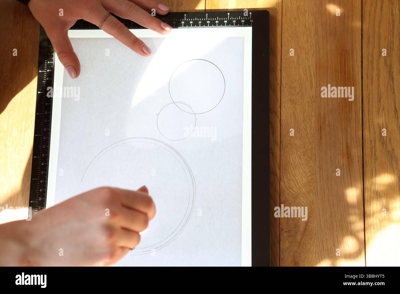 Girl drawing circles with pair of compasses and pencil maths skills ...