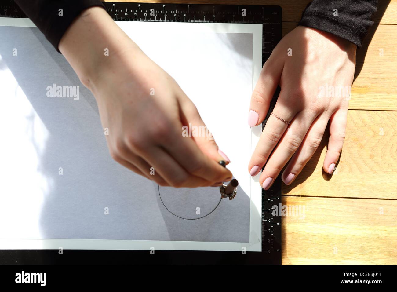 Girl drawing circle with pair of compasses and pencil maths skills ...