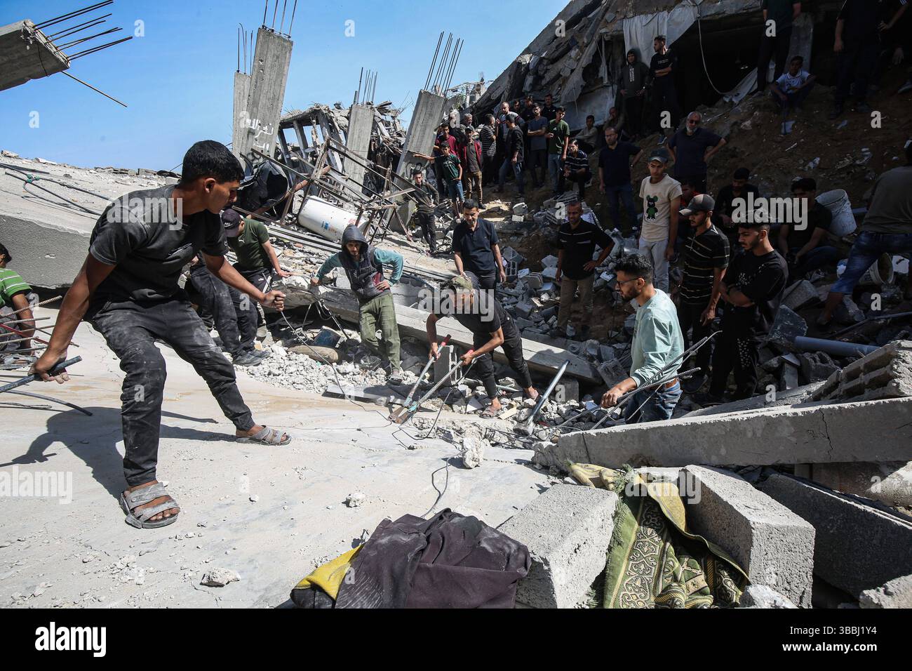 People sift through the rubble of the Zinati family home in Jabalia in ...