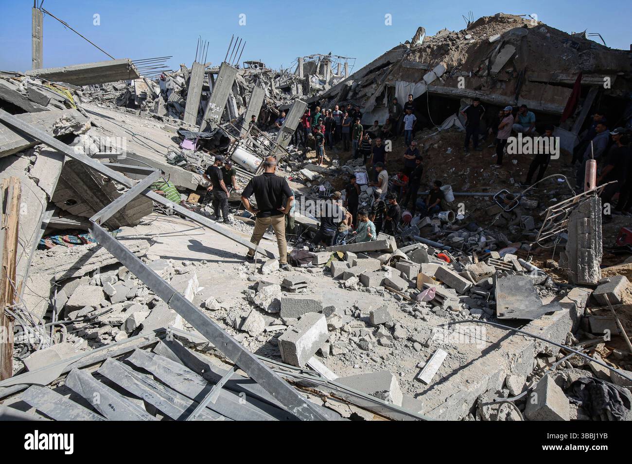 People sift through the rubble of the Zinati family home in Jabalia in ...