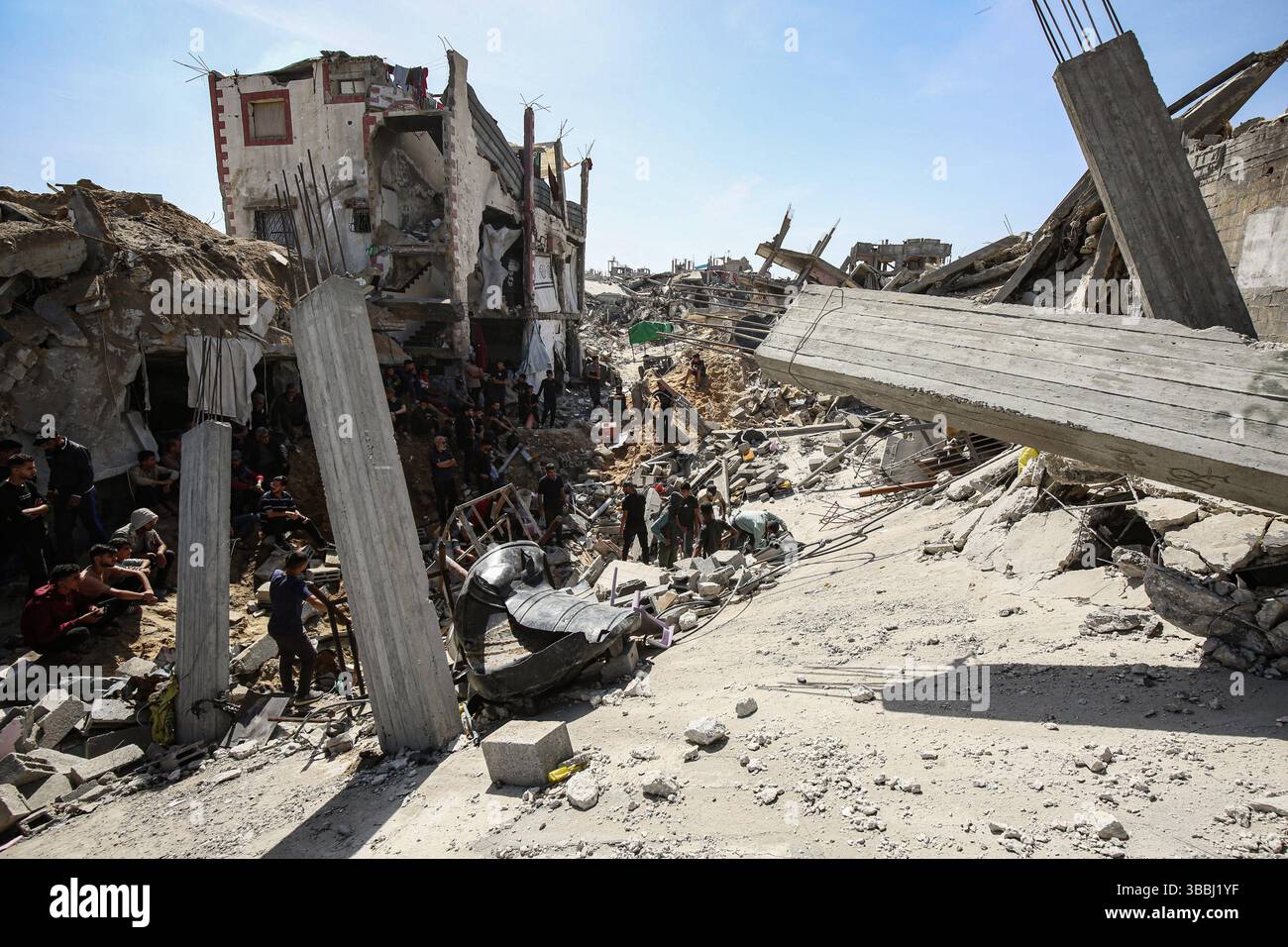 People sift through the rubble of the Zinati family home in Jabalia in ...