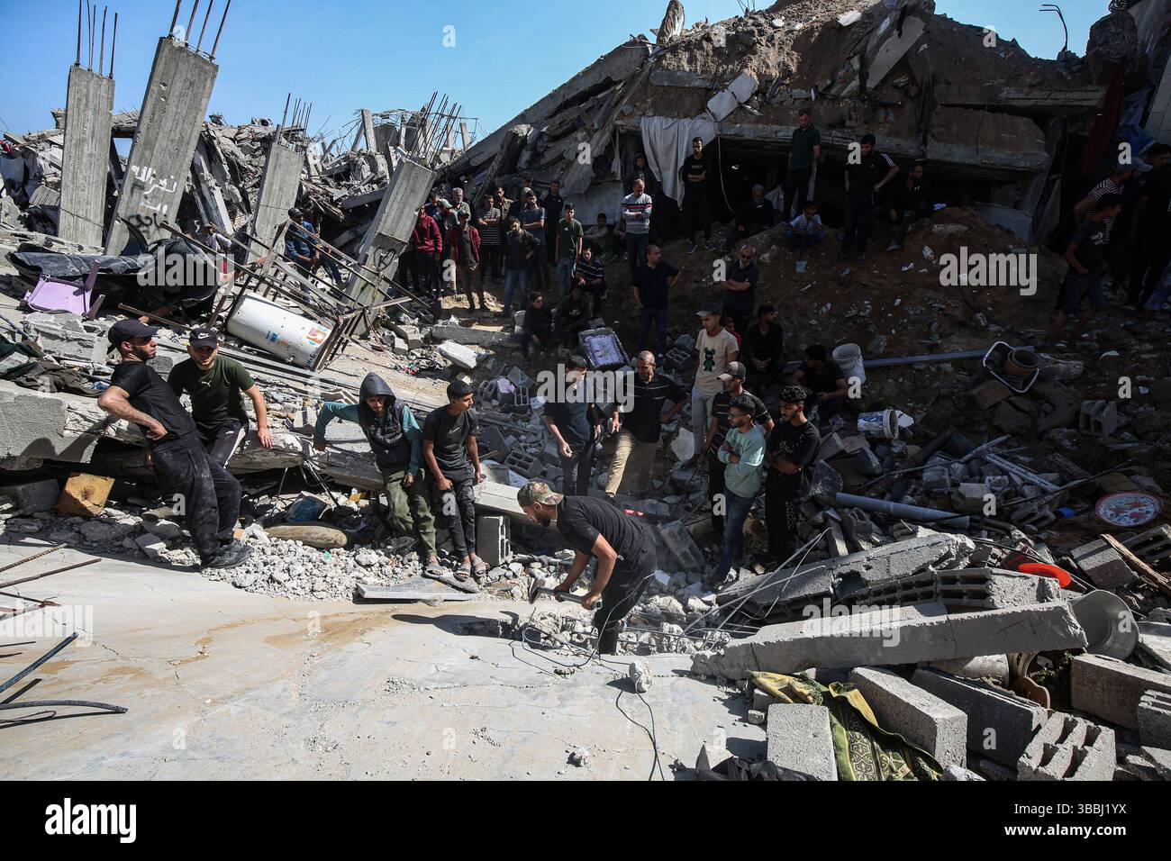 People sift through the rubble of the Zinati family home in Jabalia in ...