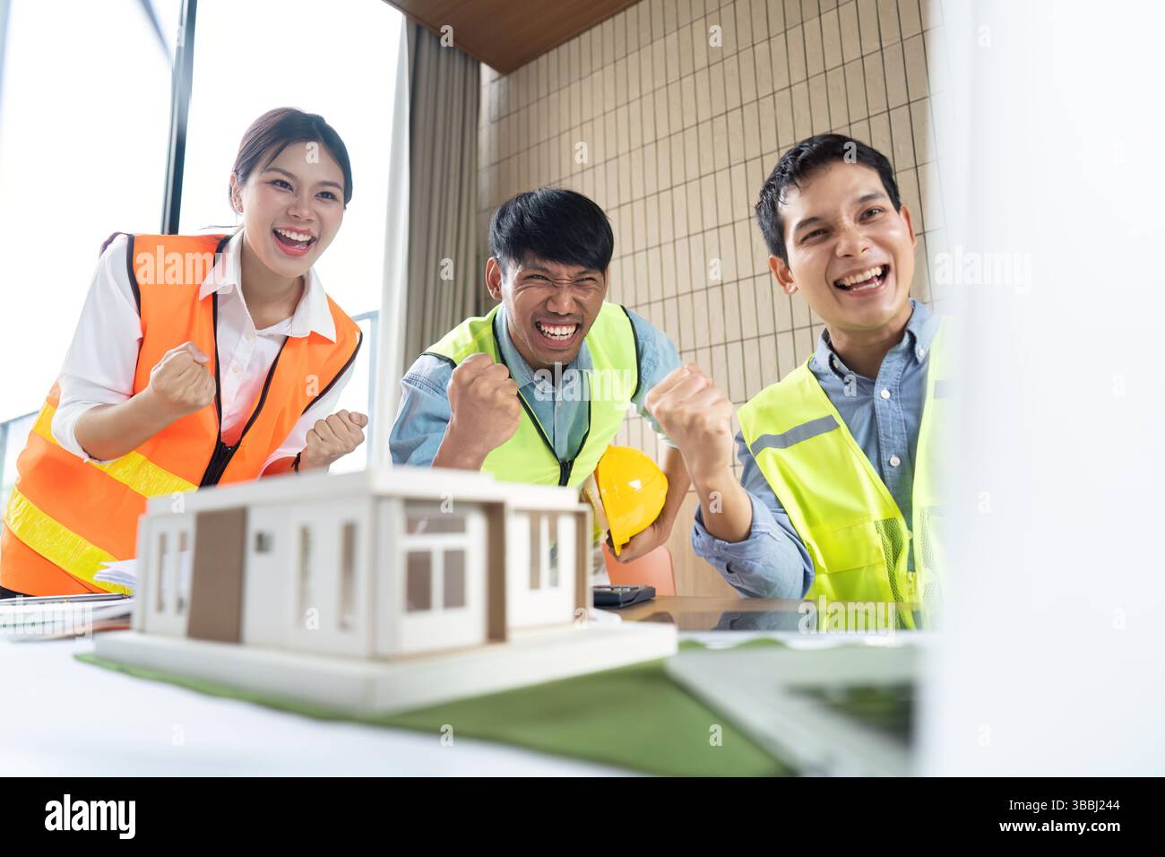 Engineers celebrating completion of sustainable construction model ...