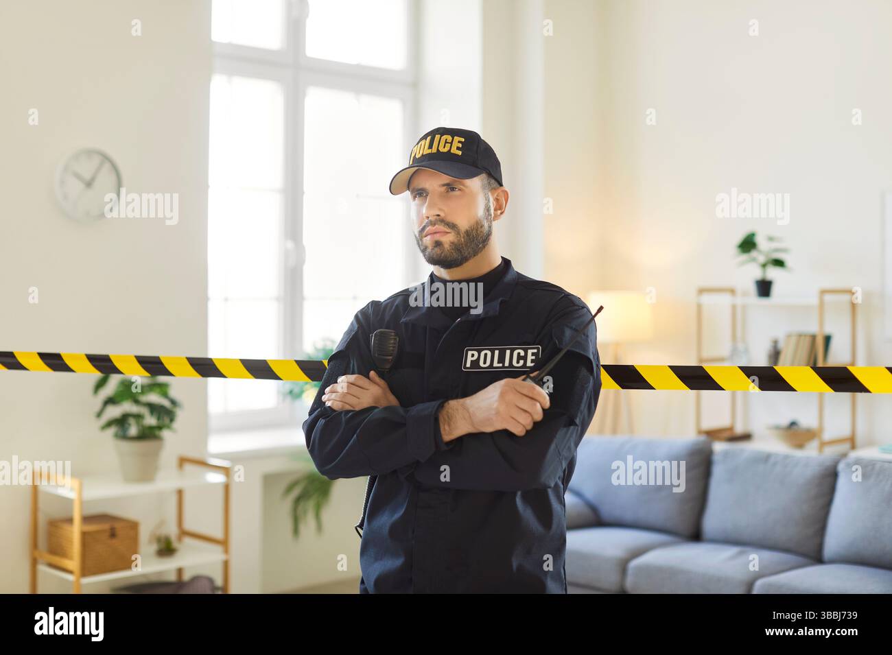 Police officer displays serious demeanor while observing crime scene in ...