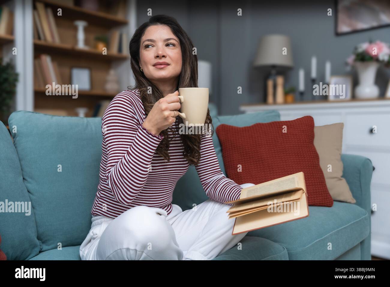 Life balance, self-esteem, mental health and independence. A young woman sits in her small ...