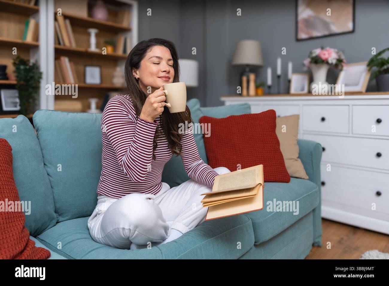 Life balance, self-esteem, mental health and independence. A young woman sits in her small ...