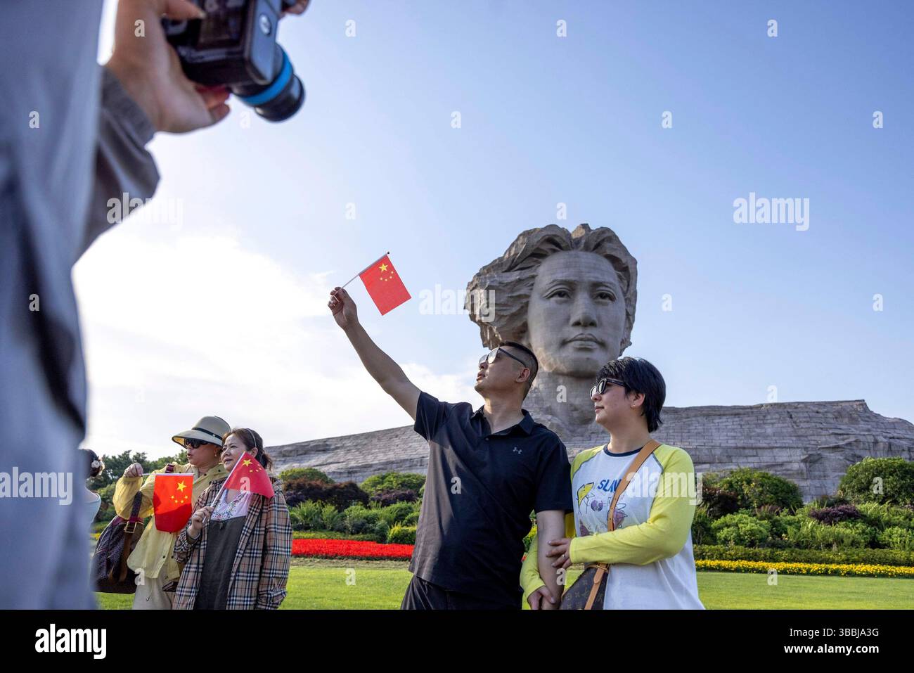 IMAGE DISTRIBUTED FOR XINHUA - Tourists pose for photos in front of the ...