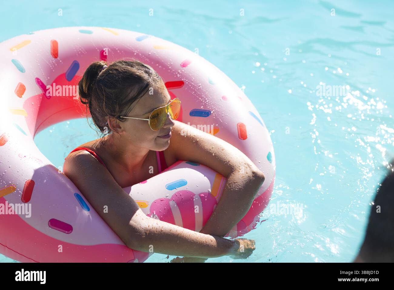 Reclining woman wearing red swimsuit, yellow shades leaning on pink ...