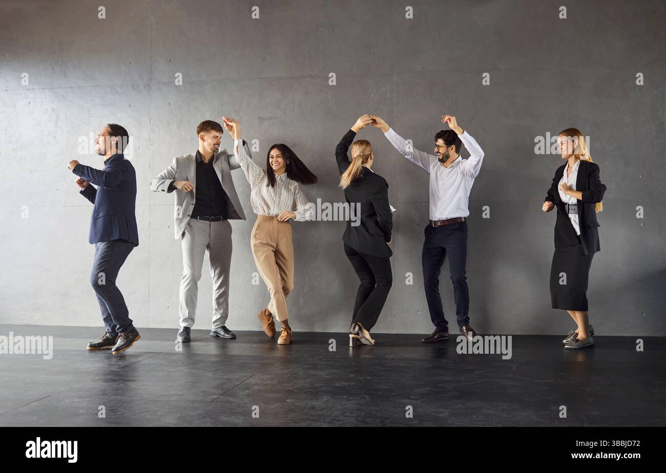 Happy overjoyed young diverse employees group dance, workers relaxing ...